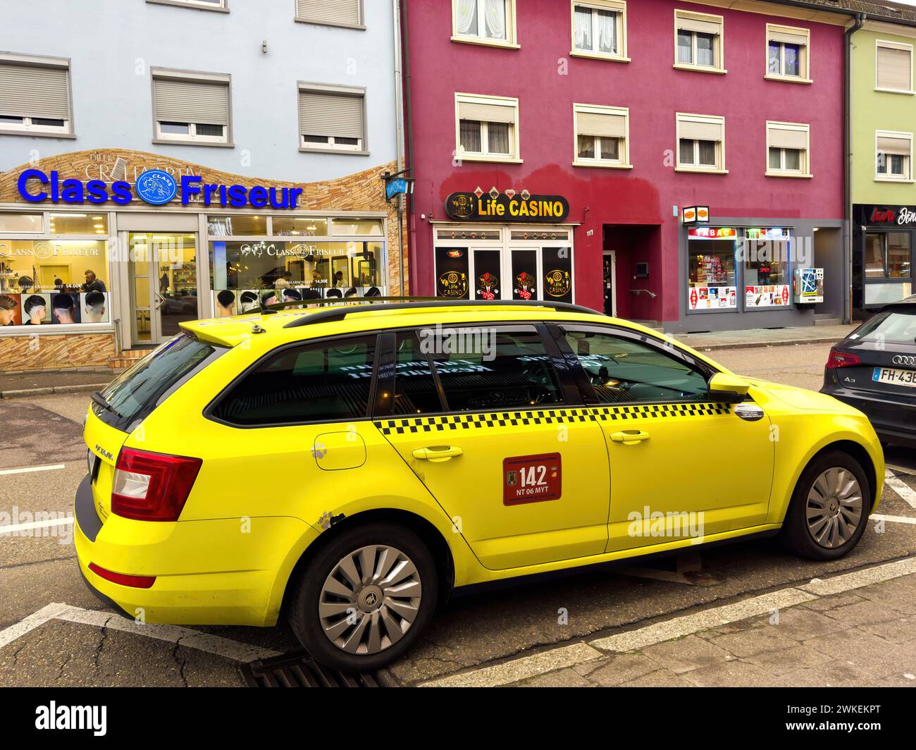 Kehl, Germany - Dec 21, 2023: cultural blend as a Romanian yellow Skoda ...