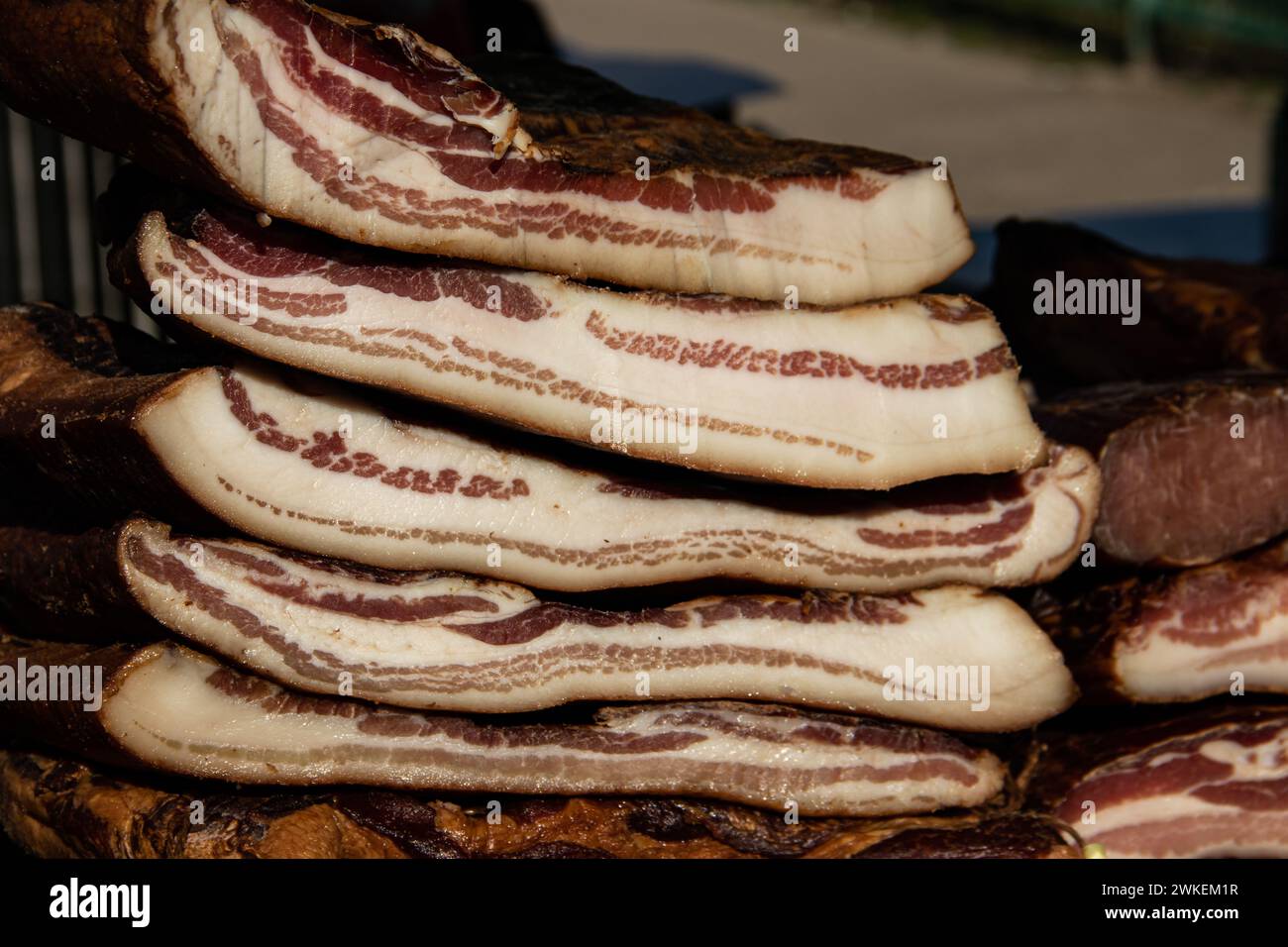 Exposed bacon and dried meat domestic products presented for sale on a ...