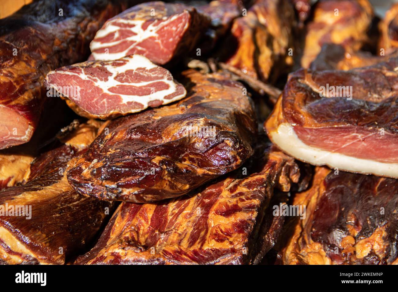 Delicious pieces of smoked meat exposed for sale in the market ...
