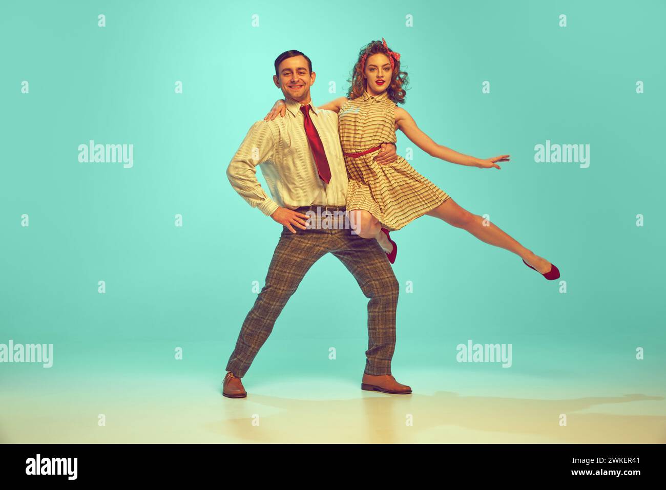 Pretty young couple in retro 80s, 90s fashion style outfit dancing ...