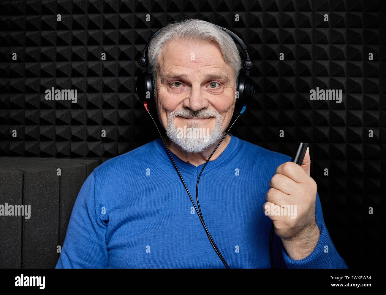 Hearing loss treatment. Positive senior man wearing audiometry ...