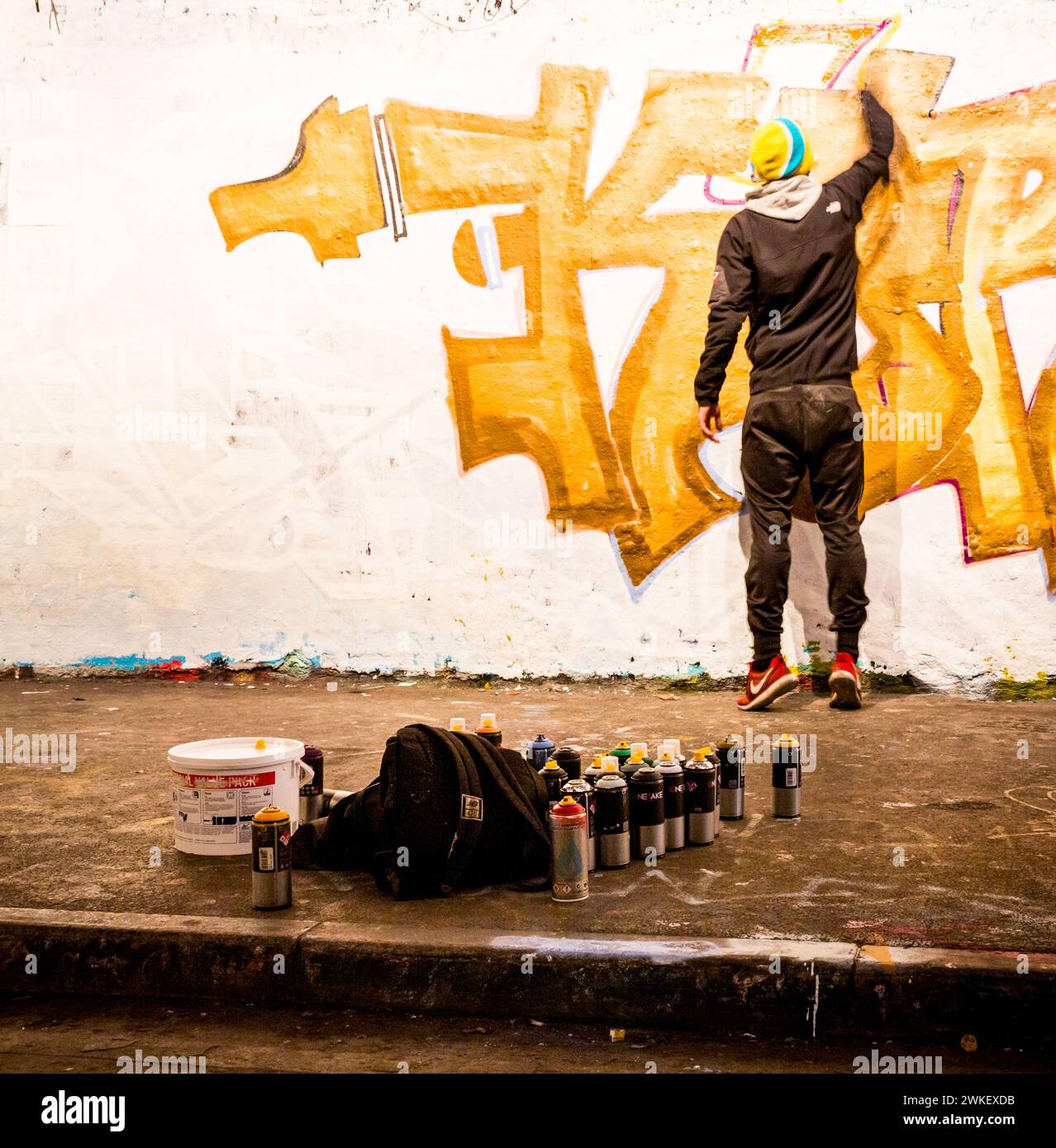 Street artists painting graffiti in the Leake Street Tunnel, London ...