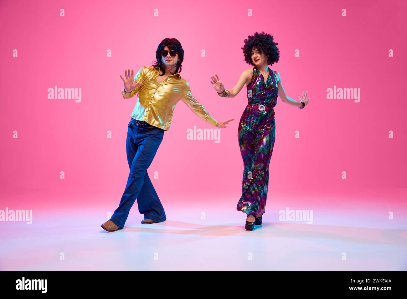 Lost in Rhythm. Young couple, man and woman in bright retro costumes in ...