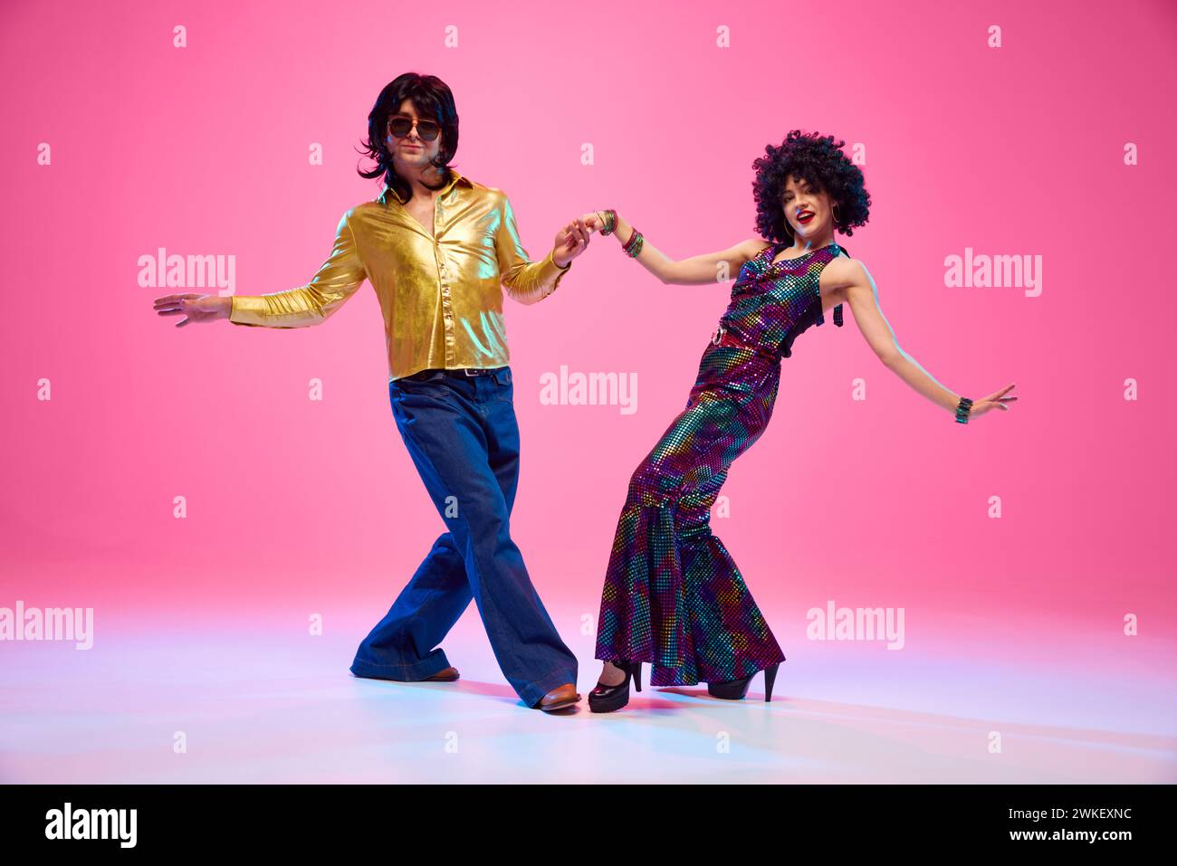 Disco Dreams. Dance duo, man and woman in retro fashion outfit dancing ...