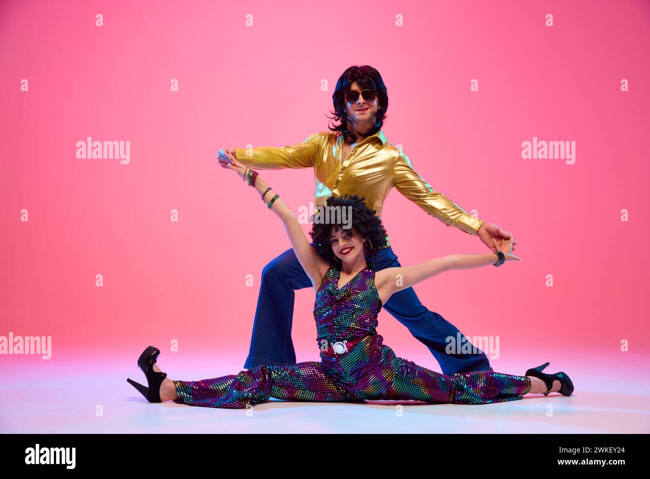 Lost in Rhythm. Young couple, man and woman in bright retro costumes in ...