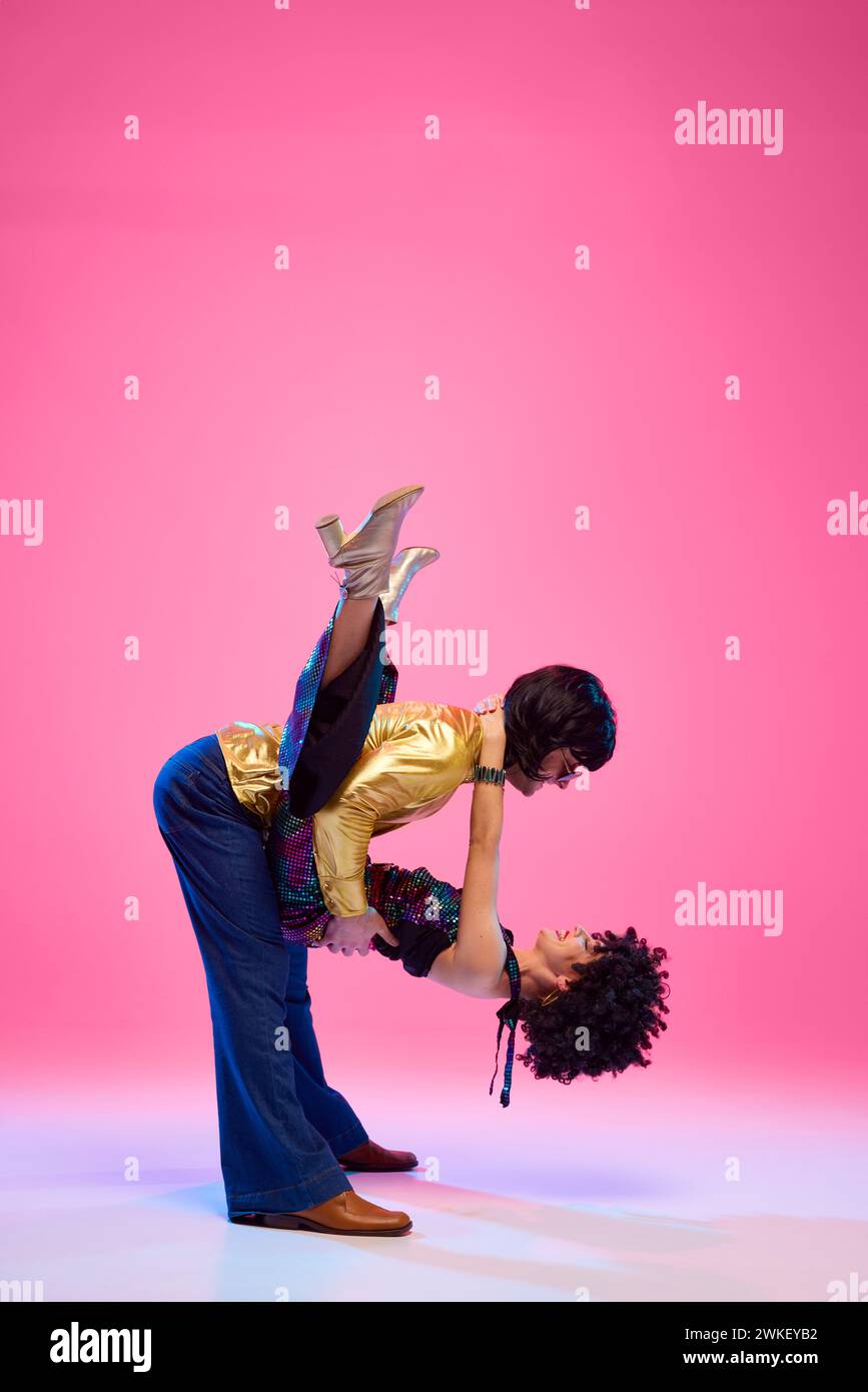 Echoes of 70s. Dance duo, female and male dancers posing in vivid retro ...