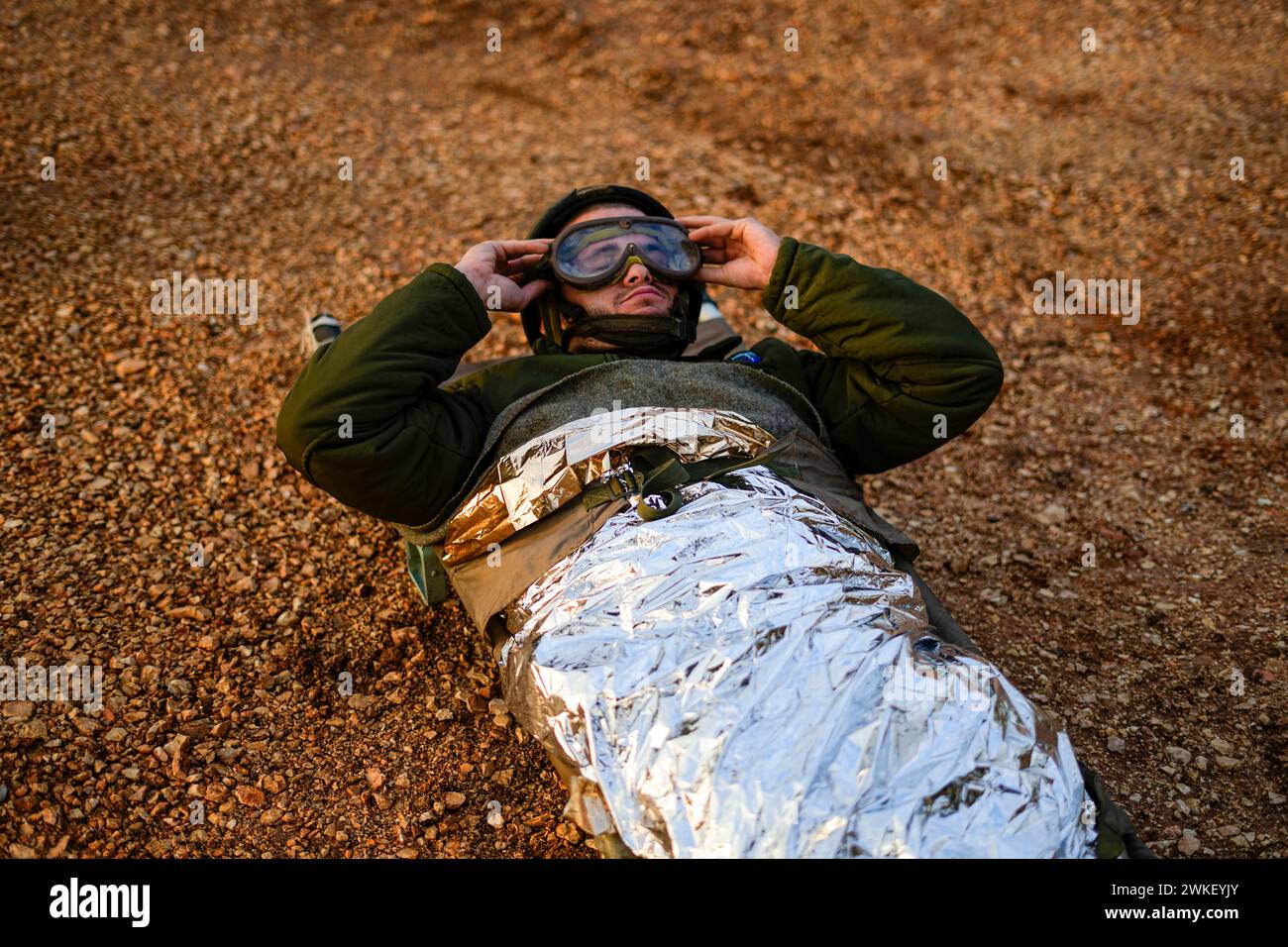 An Israeli soldier acting as wounded on a stretcher waiting to be take ...