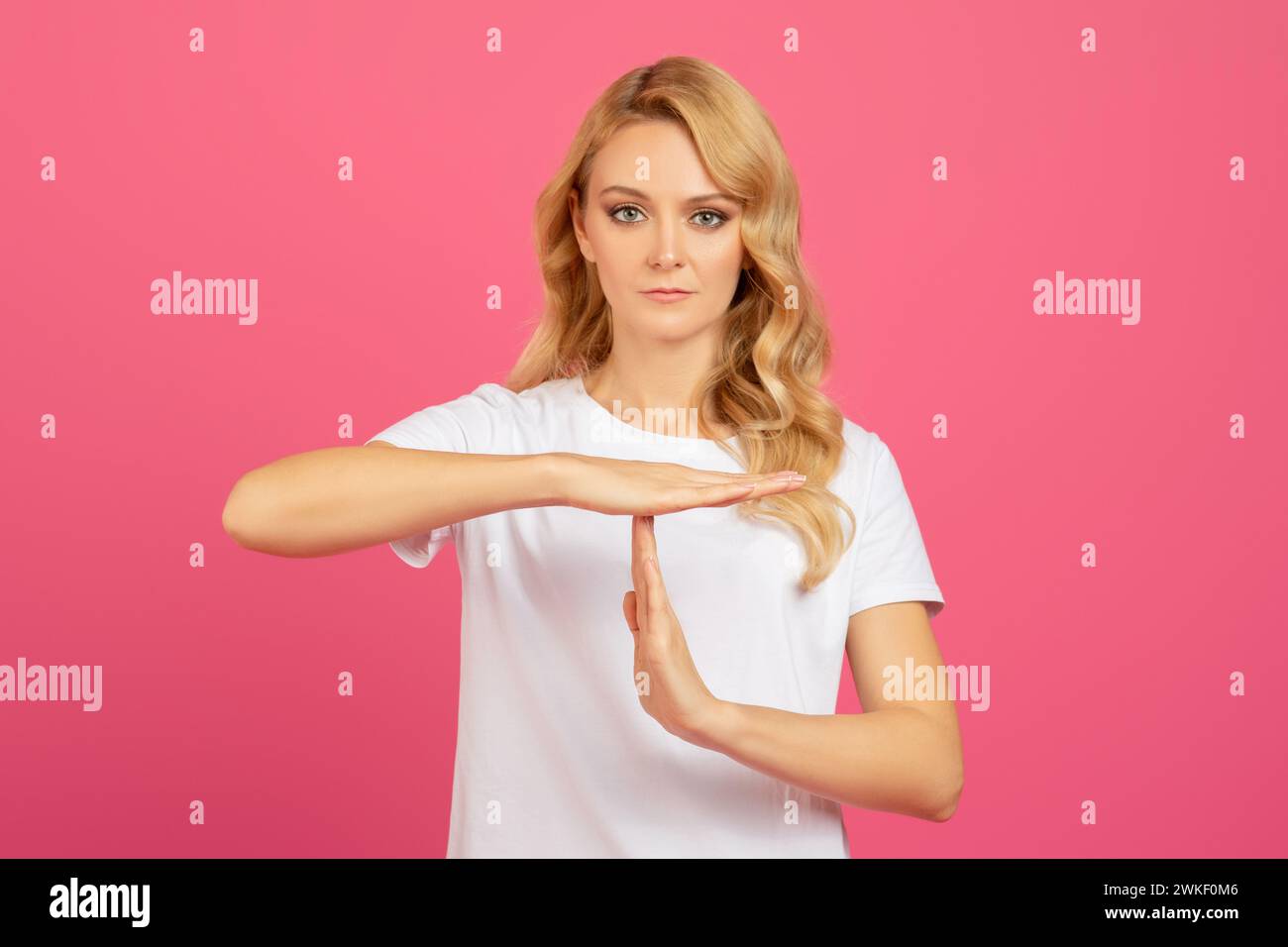 Determined Young Blonde Lady Showing Timeout Gesture Over Pink ...