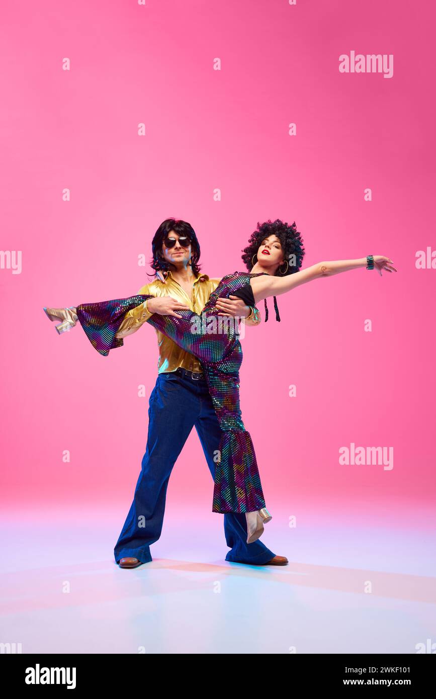 Dynamic portrait of dancers duo, man and woman, posing in retro fashion ...