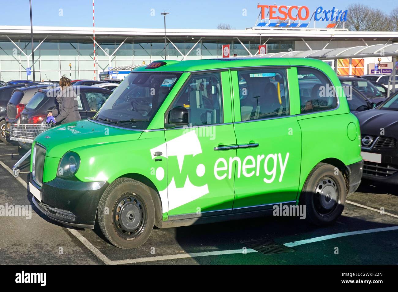 Ovo energy brand logo side of parked green taxi cab advertising a ...
