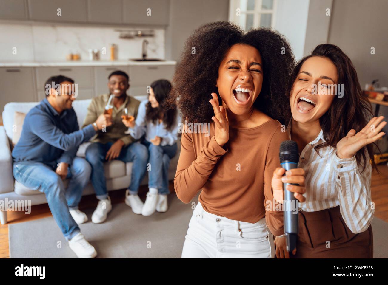 young diverse friends singing engaging in students party activities ...
