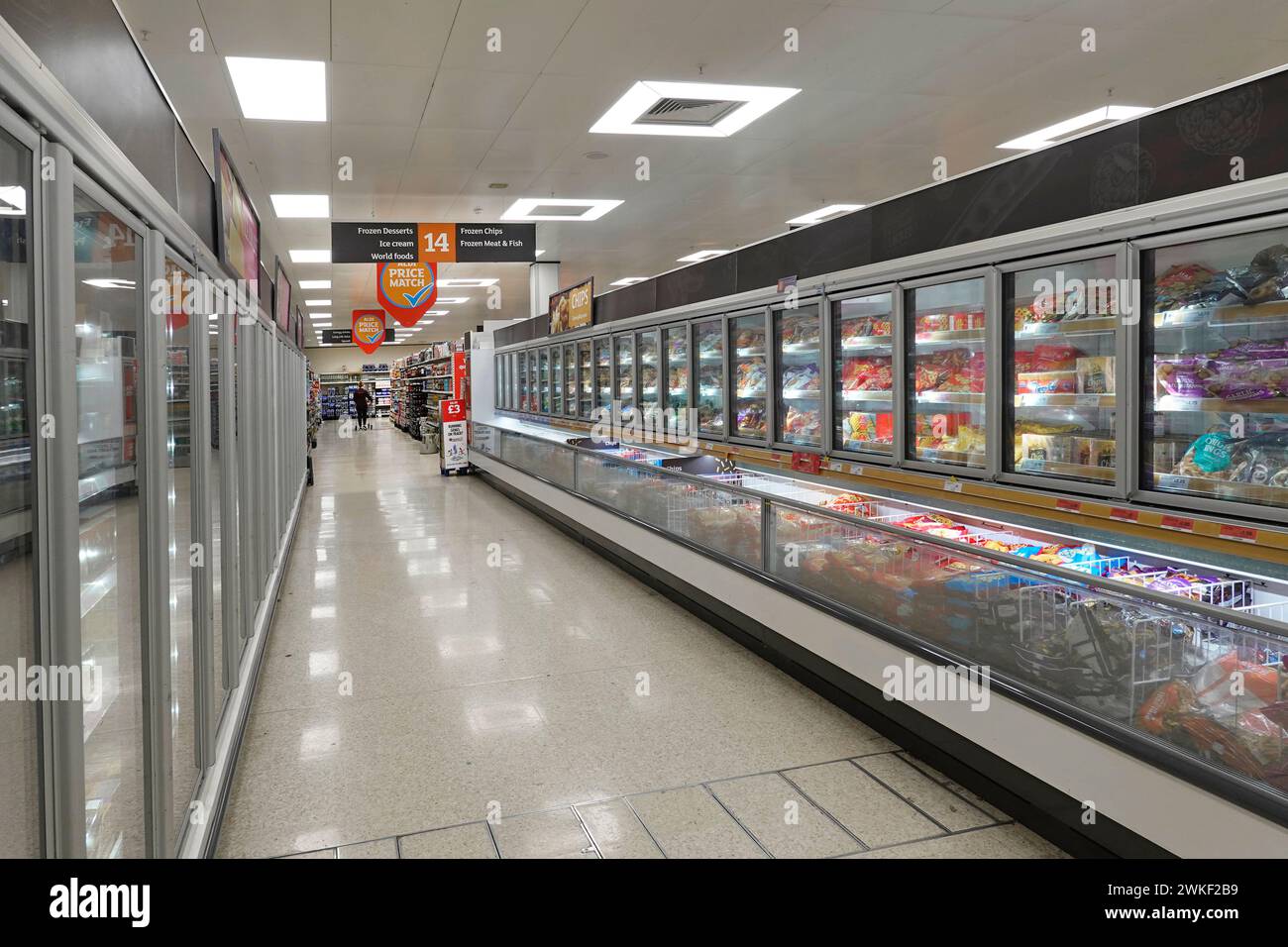 Frozen food shopping aisle in Sainsburys supermarket store interior ...