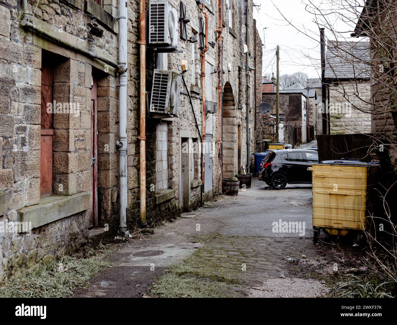Dark and damp back alleyway of a northern town in England old and ...