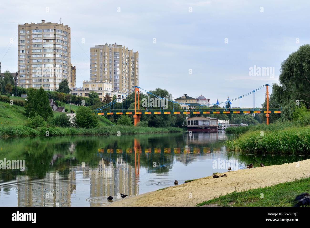 Two high-rise buildings are reflected on the surface of the river on ...