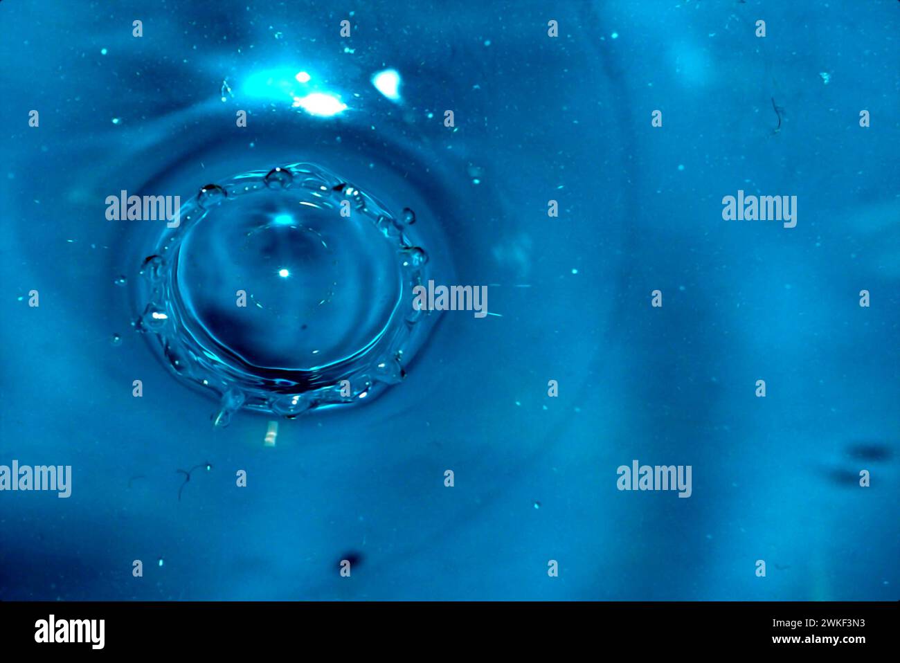 The falling drop of water created a crown of waves Stock Photo - Alamy