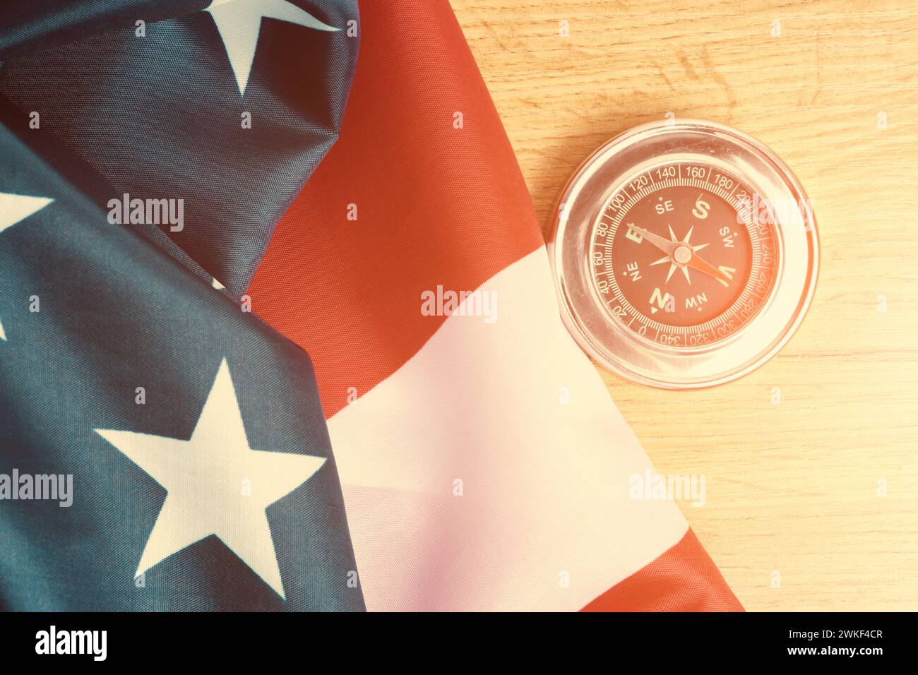 Compass pointing west and star spangled flag United States America ...