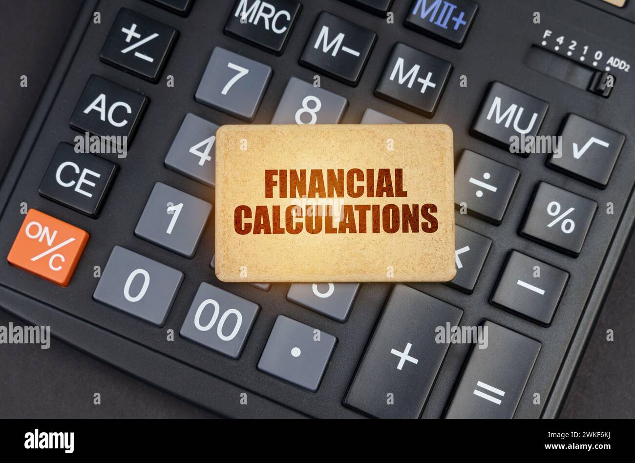 Financial concept. There is a sign on the calculator that says ...