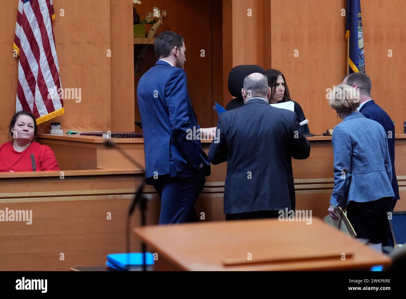 Judge Amy Messer, seated at right, listens to defense and prosecution ...