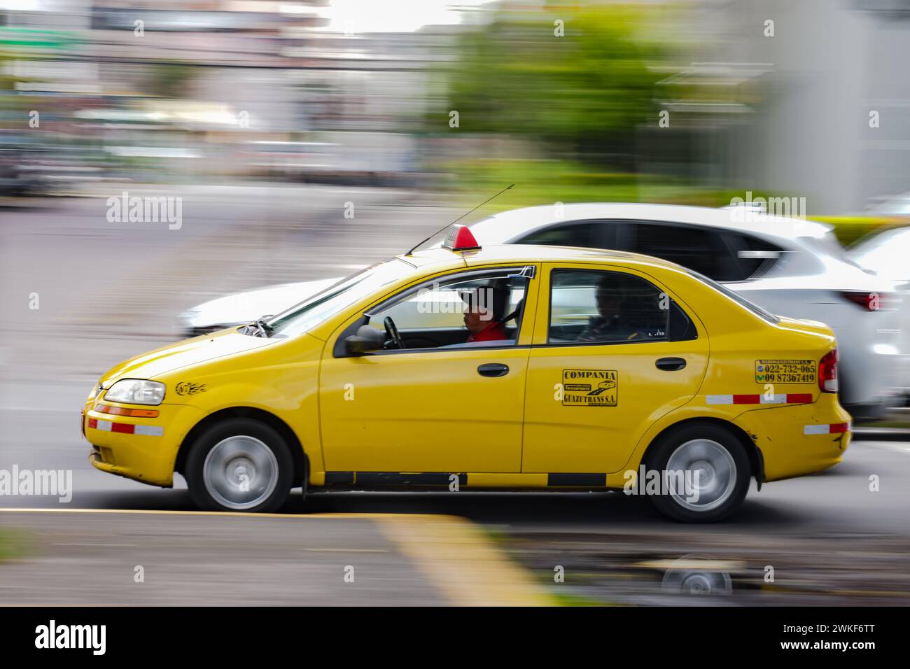 Moving yellow taxi with a blurred background in the streets of Quito ...