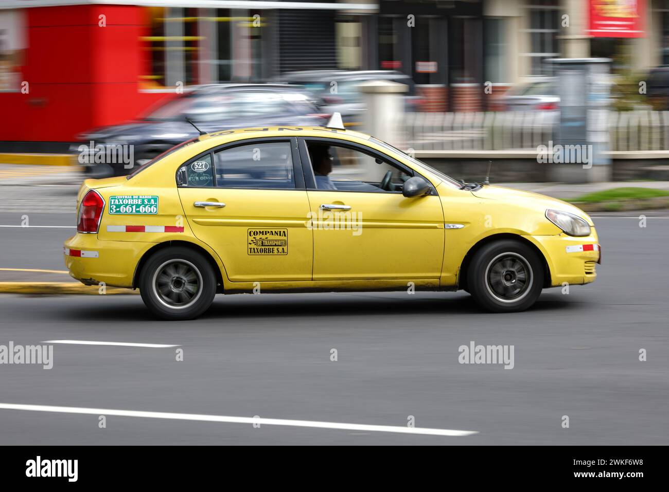 Moving yellow taxi with a blurred background in the streets of Quito ...