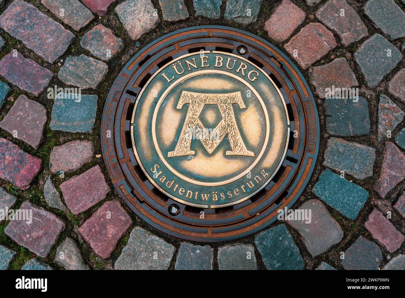 Manhole cover with the city brand in the old town of Lüneburg in ...