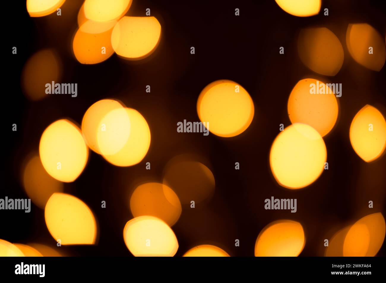 Bright yellow, gold lights, bokeh on black background. festive texture ...