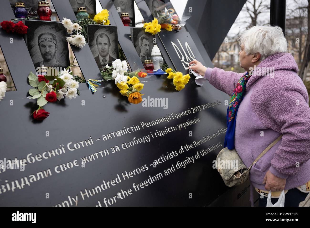 Kyiv, Ukraine. 20th Feb, 2024. A woman pays tribute to the activists ...