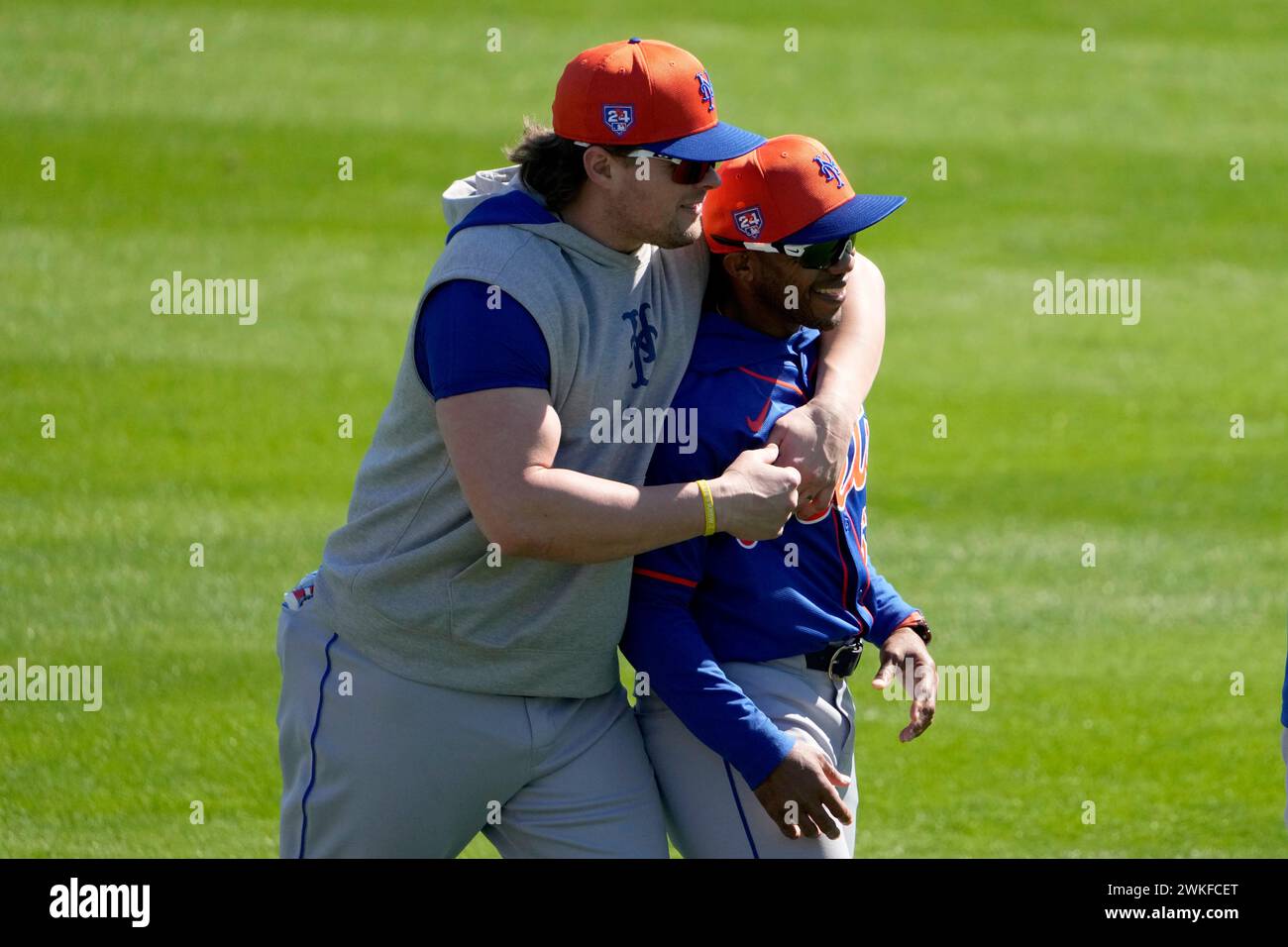 New York Mets' Luke Voit hangs first base coach Antoan Richardson ...