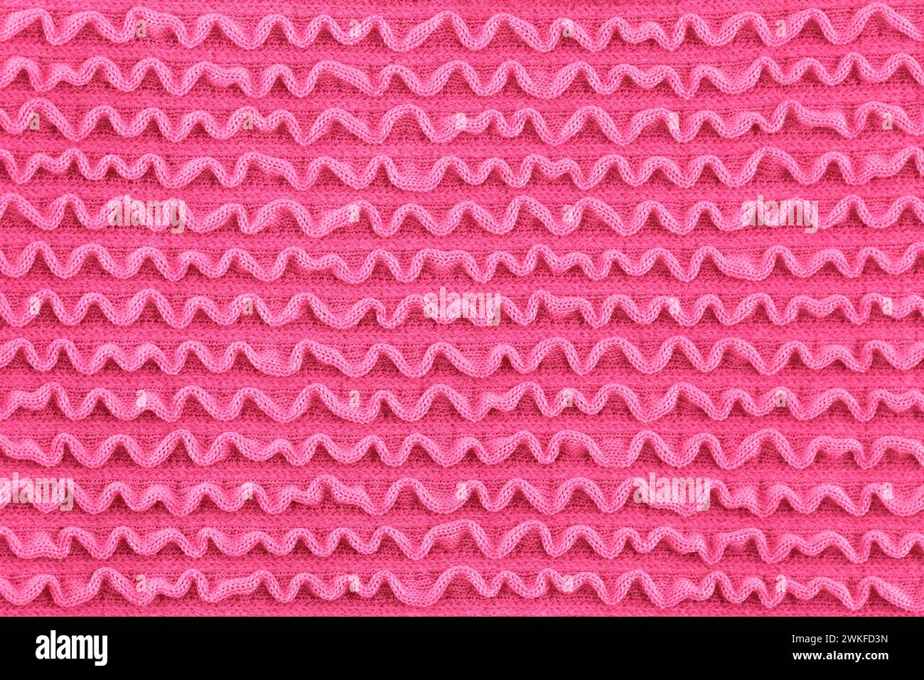 close up of pink fabric texture with waves, abstract tissue background ...