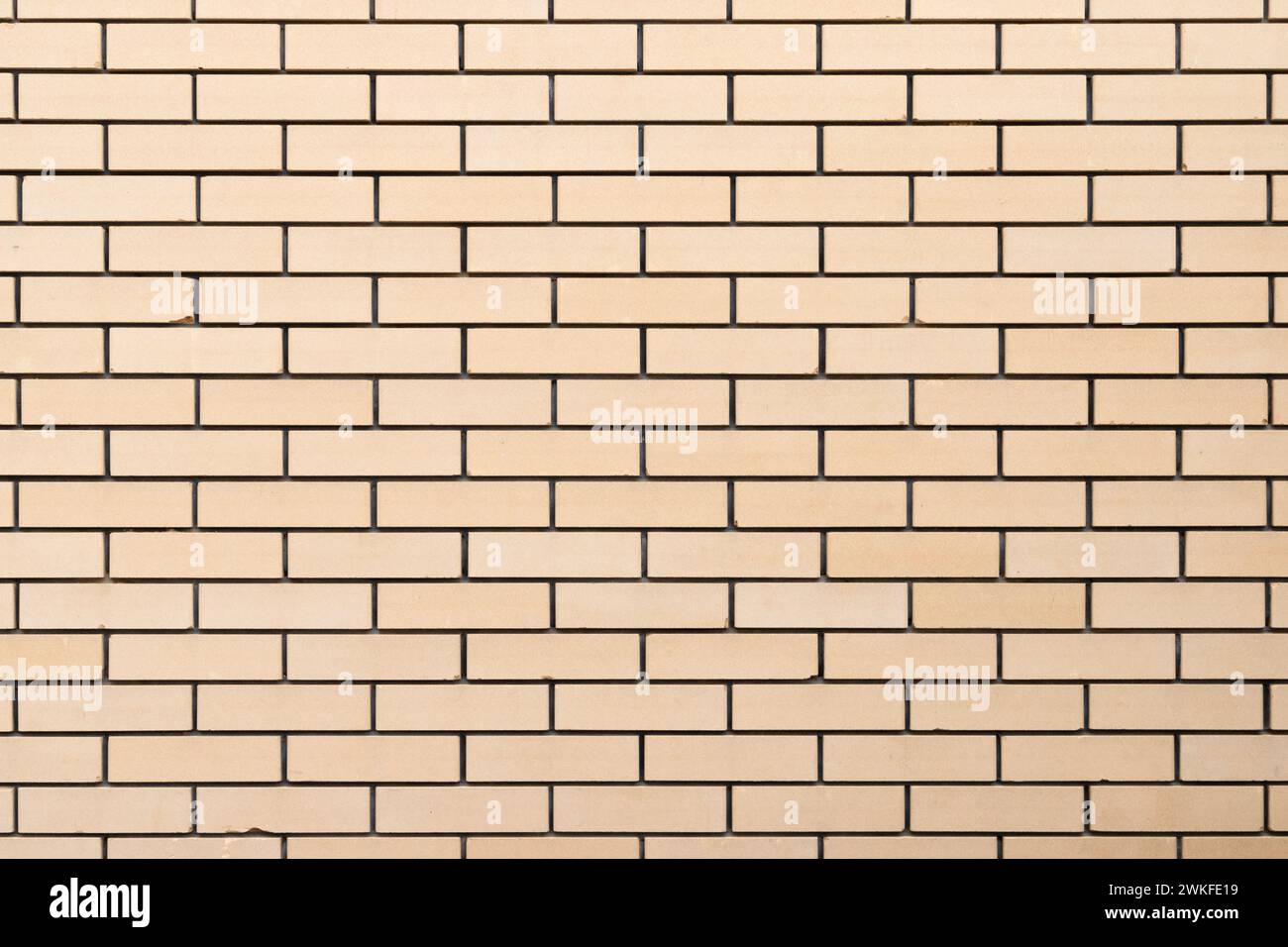 Yellow brick wall, front view, background photo texture Stock Photo - Alamy