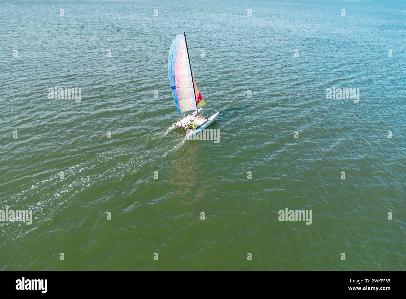 Aerial drone view of a catamaran sailboat sailing in the Turquoise ...