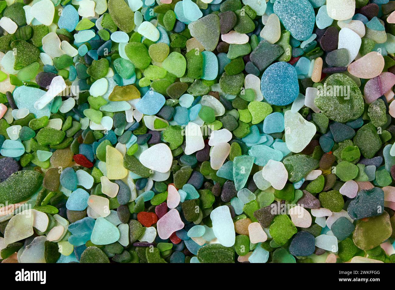 Multi-colored background from sea-polished glass shards of bottles ...