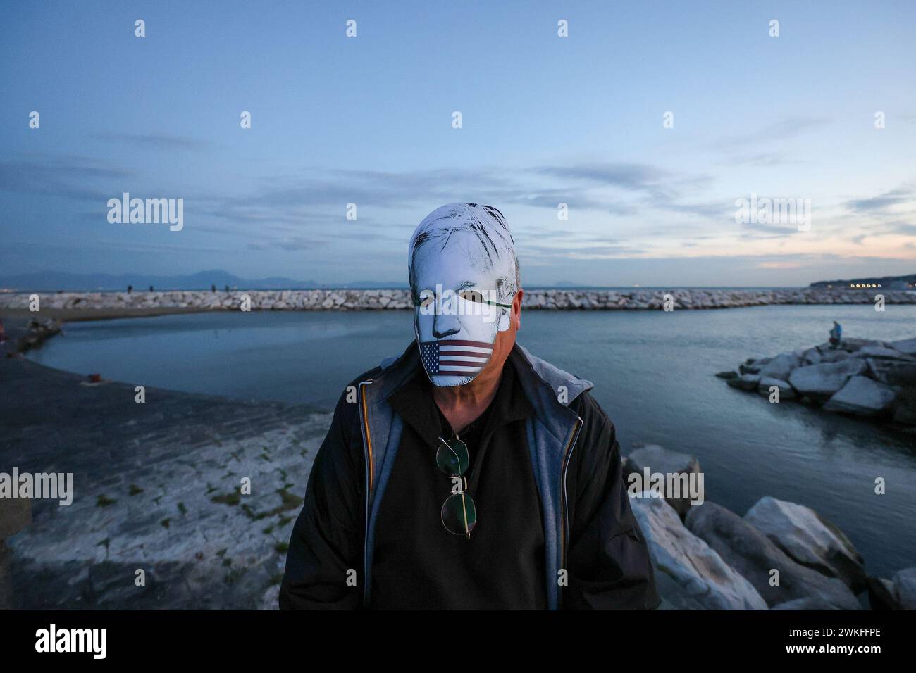 Napoli, Italy, 20 February 2024. A man with an Assange's mask sitting ...