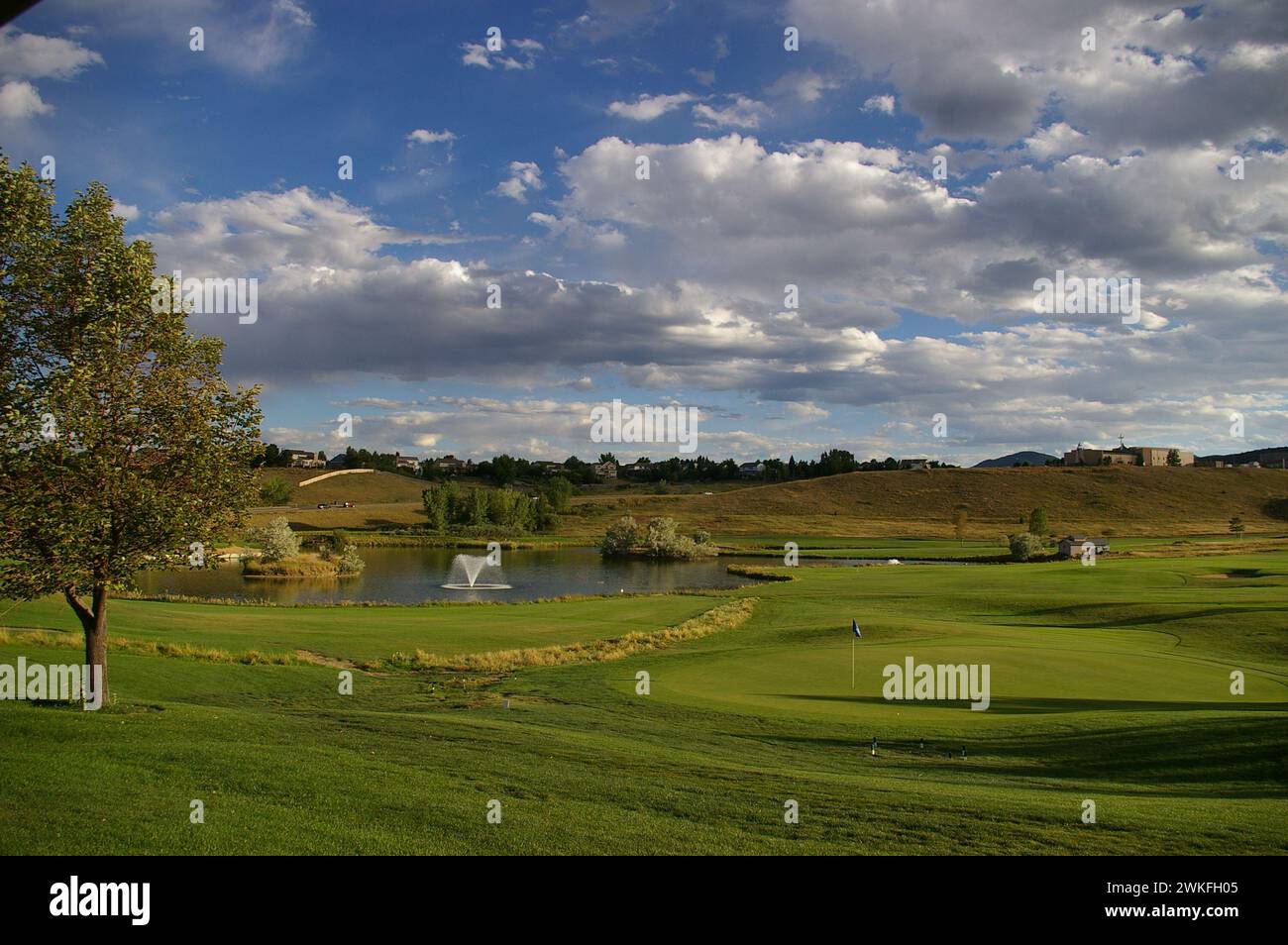 Scenic golf course fairgrounds by a pond with lush grass Stock Photo ...