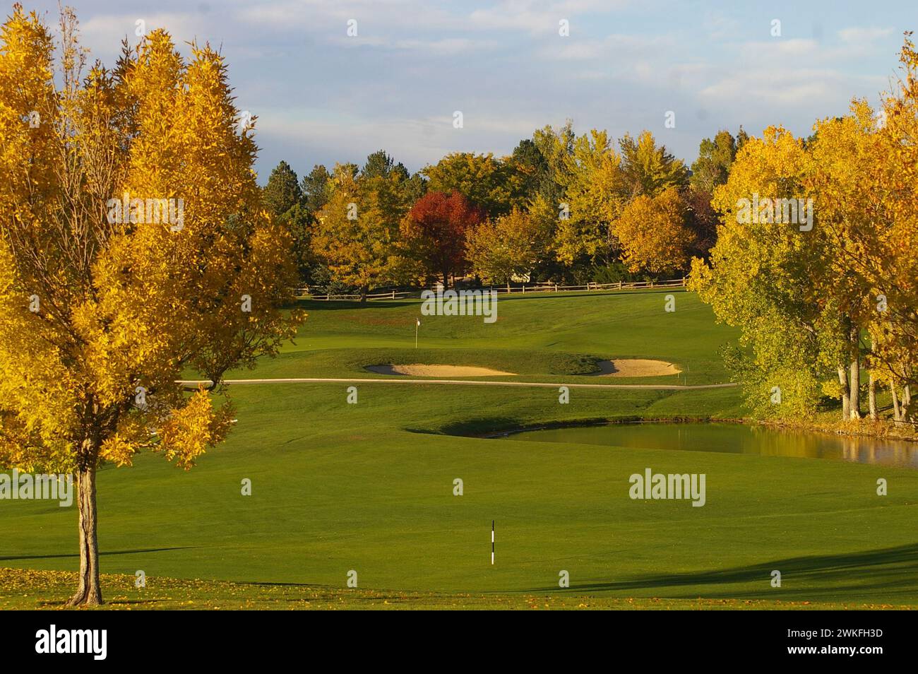 A Scenic golf course with trees, grass, and water in the foreground ...