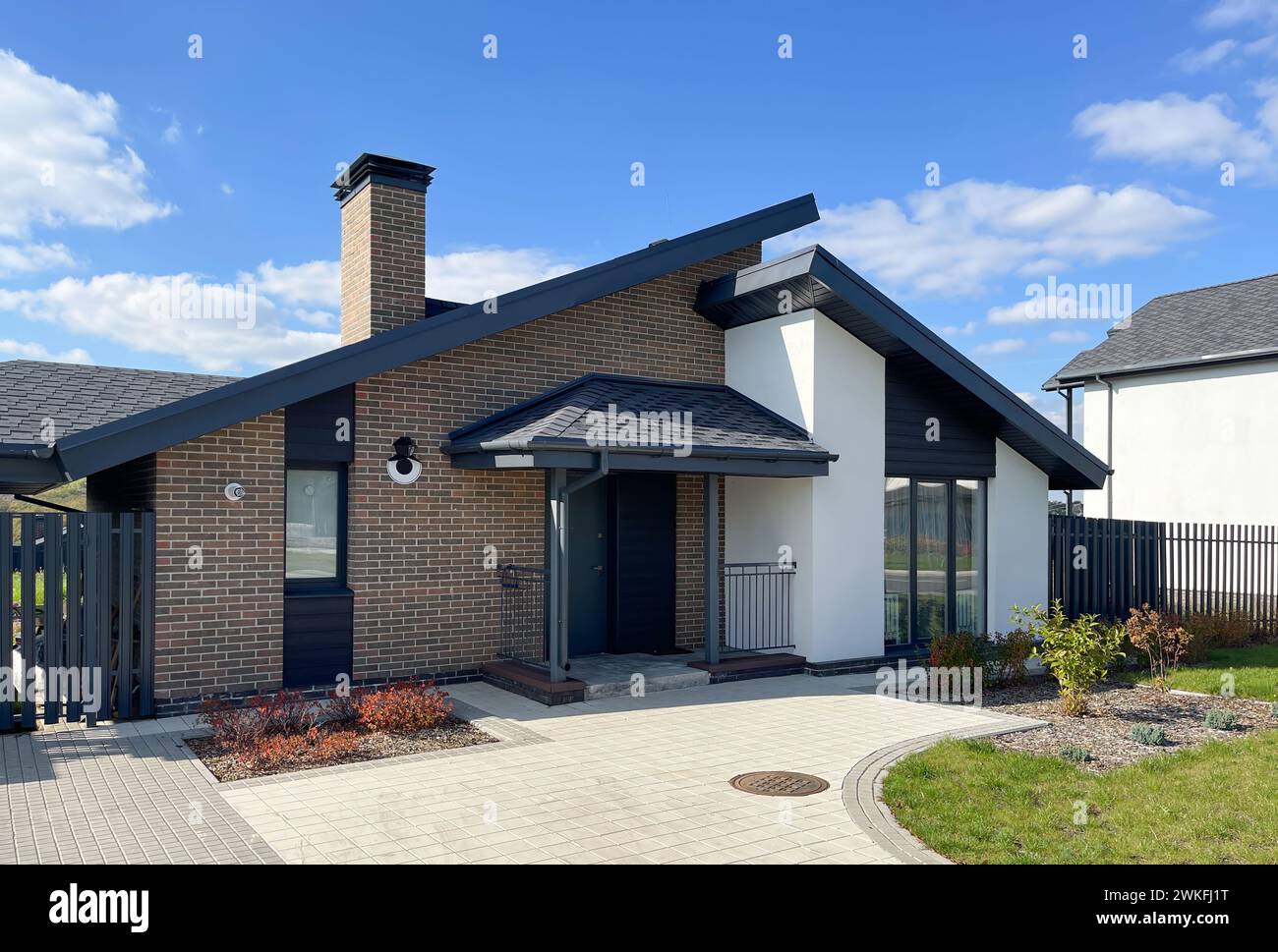Modern suburban house with a two-level roof Stock Photo - Alamy