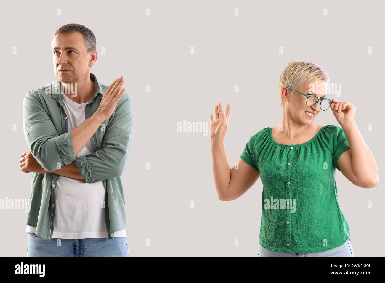 Offended mature couple after quarrel on light background Stock Photo ...