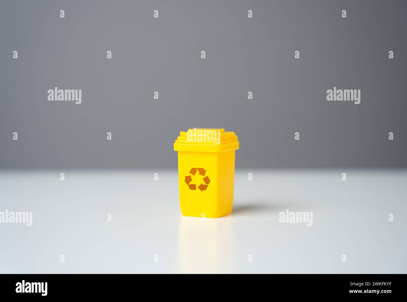 Yellow recycling bin. Circular economy. Selling recycled material or ...