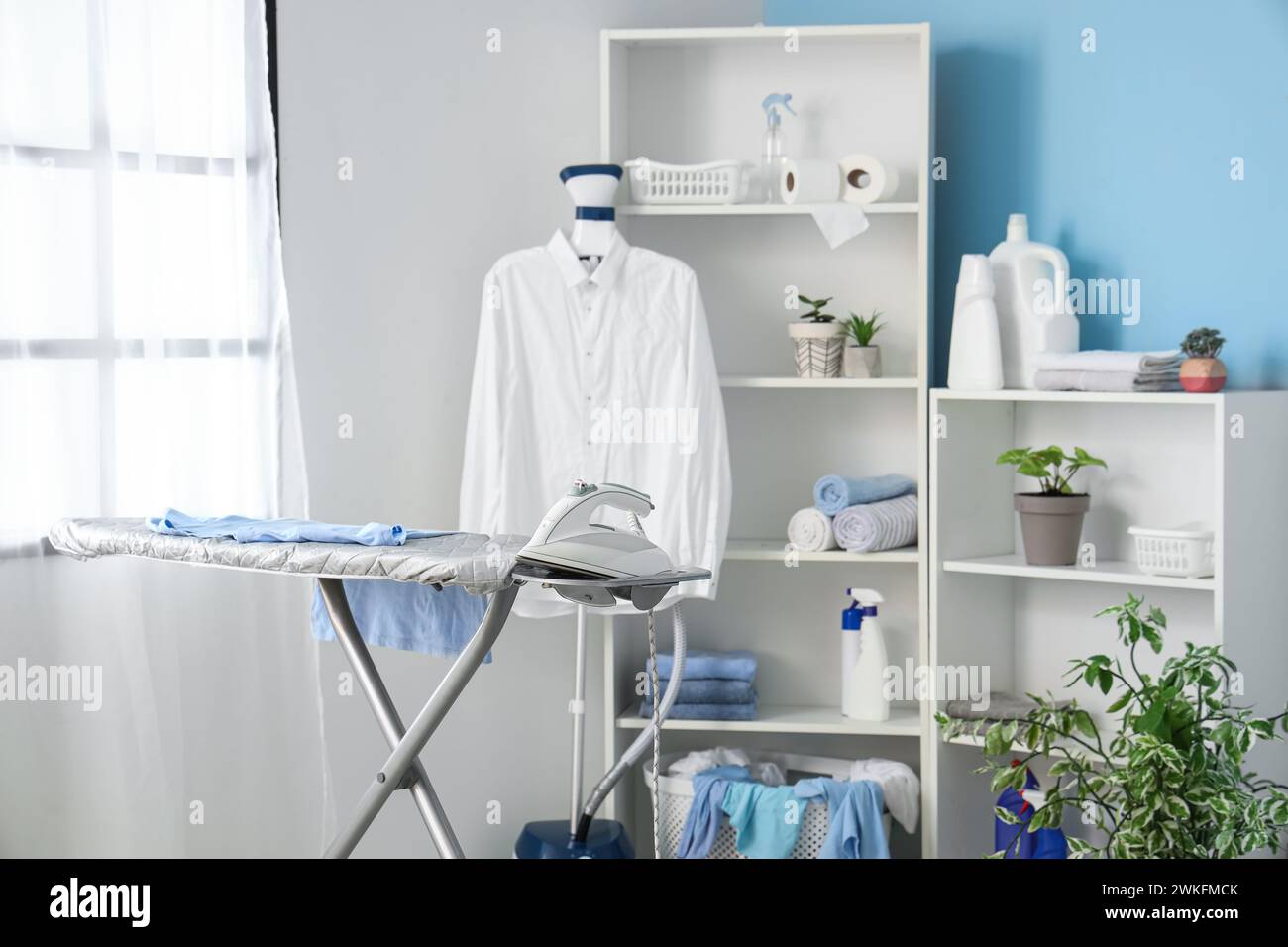 Interior of modern laundry room with ironing board and steamer Stock ...