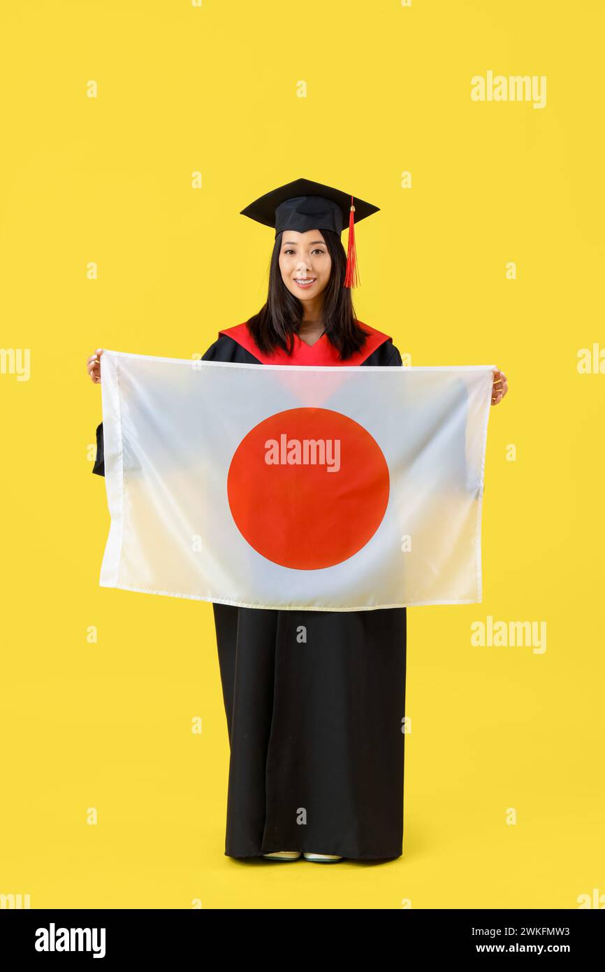 Female Asian graduate with flag of Japan on yellow background Stock ...