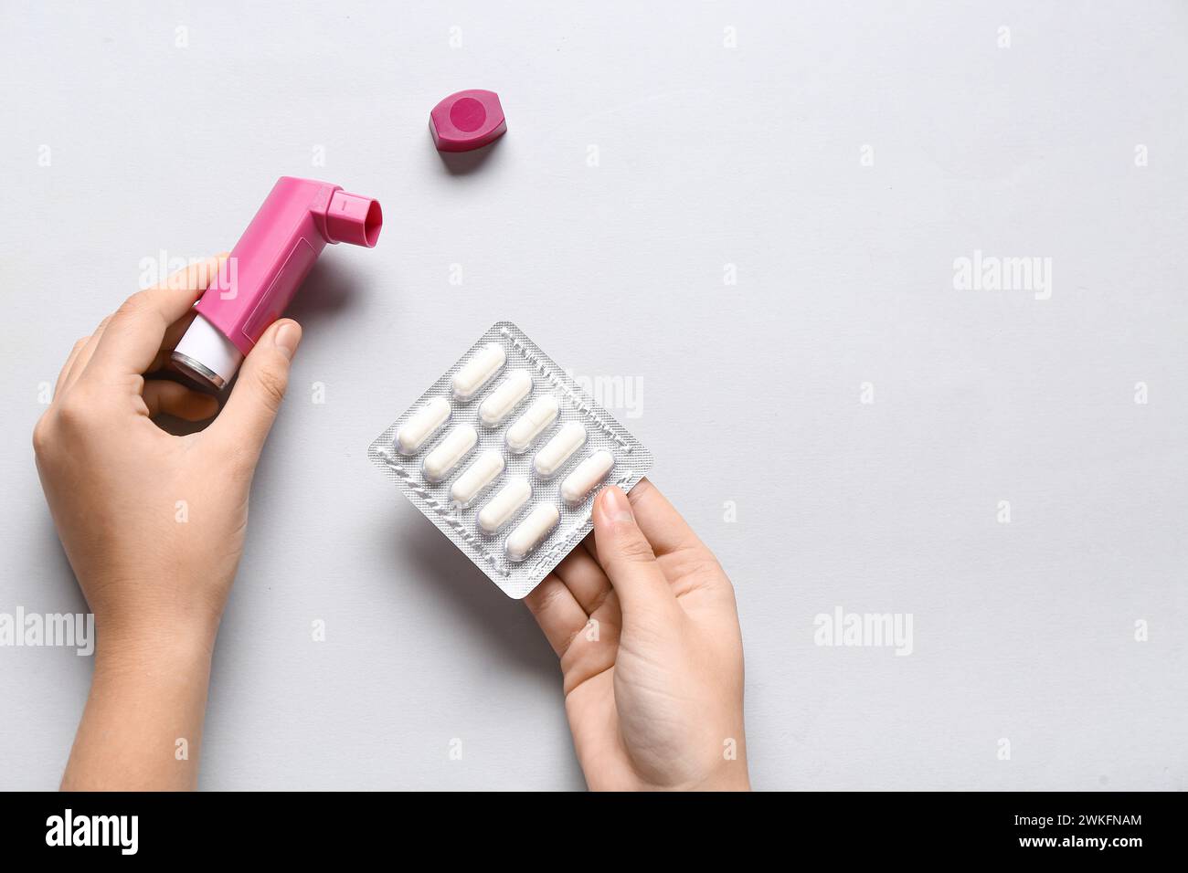 Child's hands with asthma inhaler and pills on white background Stock ...