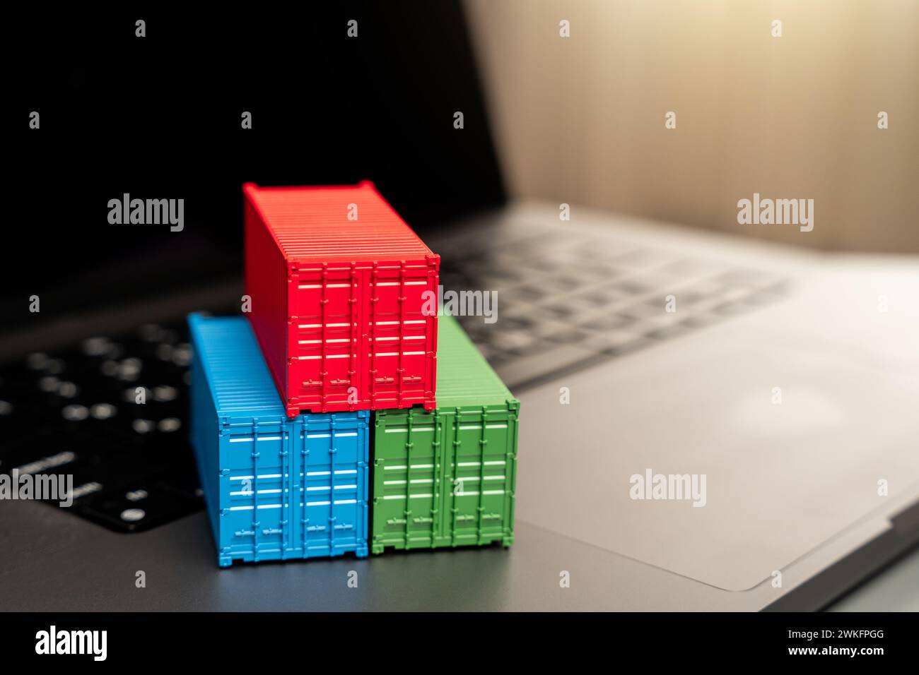 Ship container on laptop keyboard. Trade, economics and transport ...