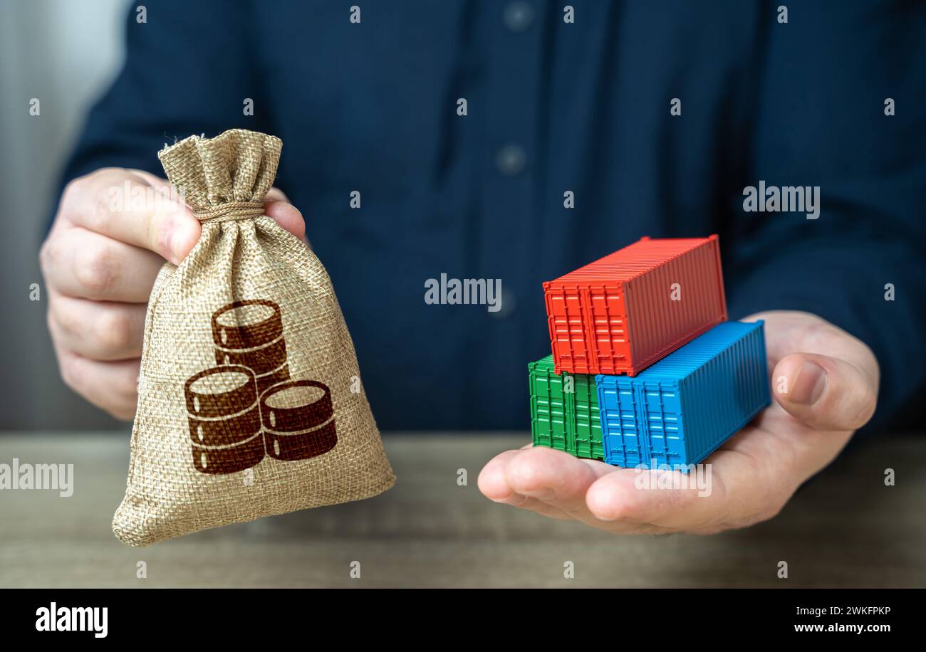 Trade containers and a money bag in the hands of a businessman ...