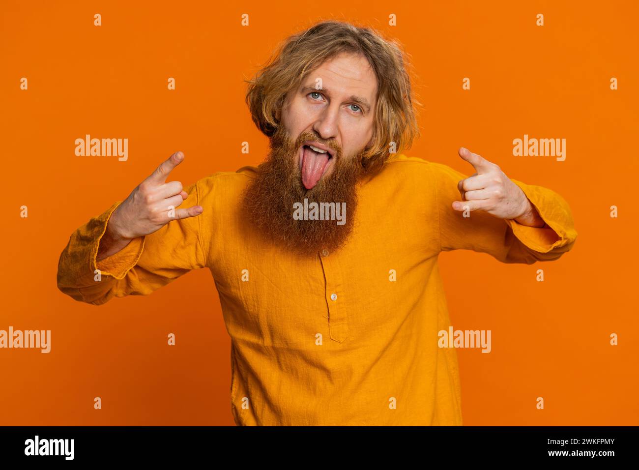 Overjoyed happy Caucasian man showing rock n roll gesture by hands ...