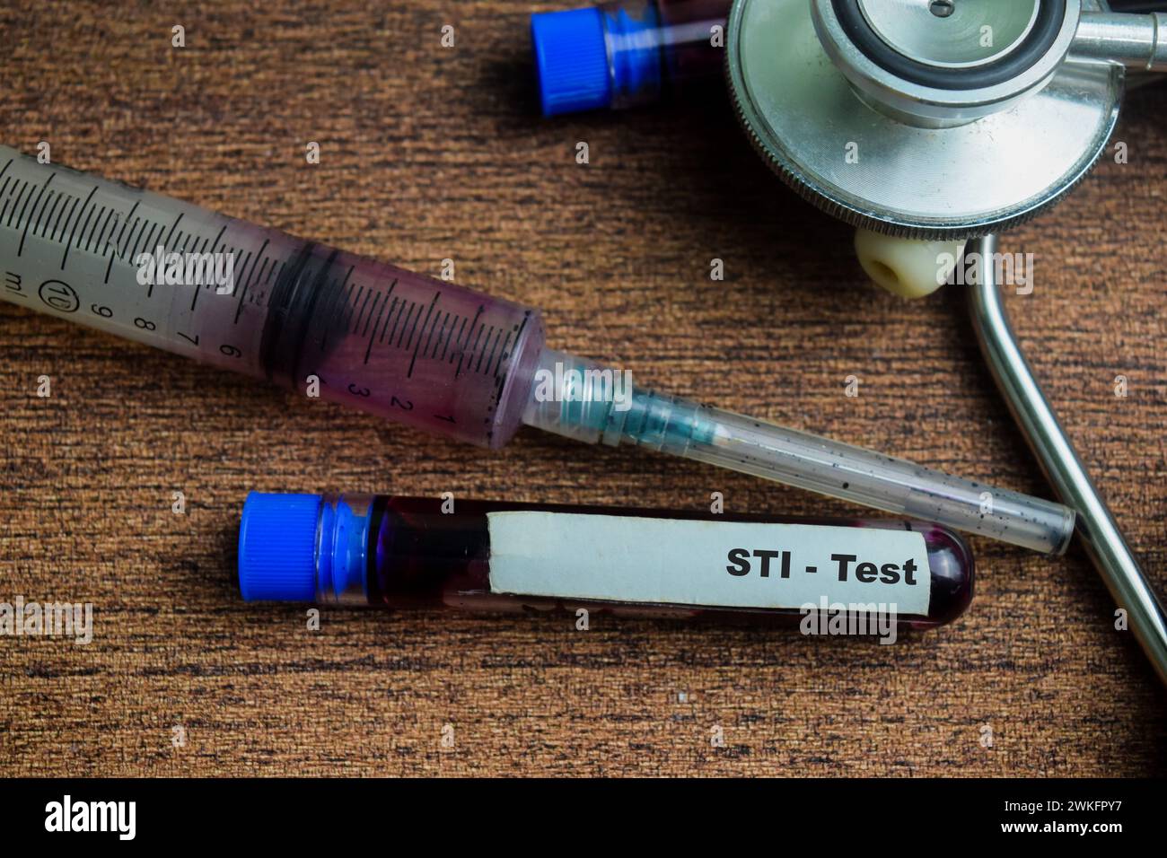 STI - Test with blood sample on wooden background. Healthcare or ...