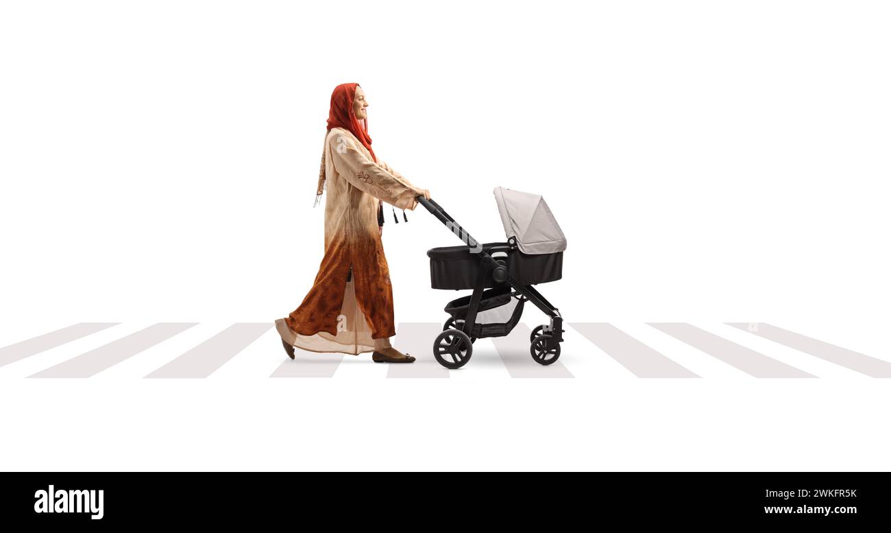 Full length profile shot of a woman wearing a hijab and pushing a baby ...