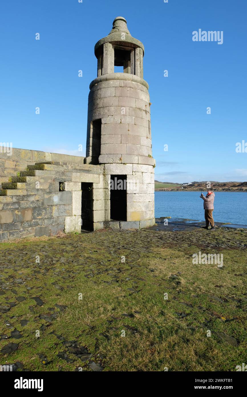 Port Logan Galloway Scotland - A visitor looks at the quay and bell ...