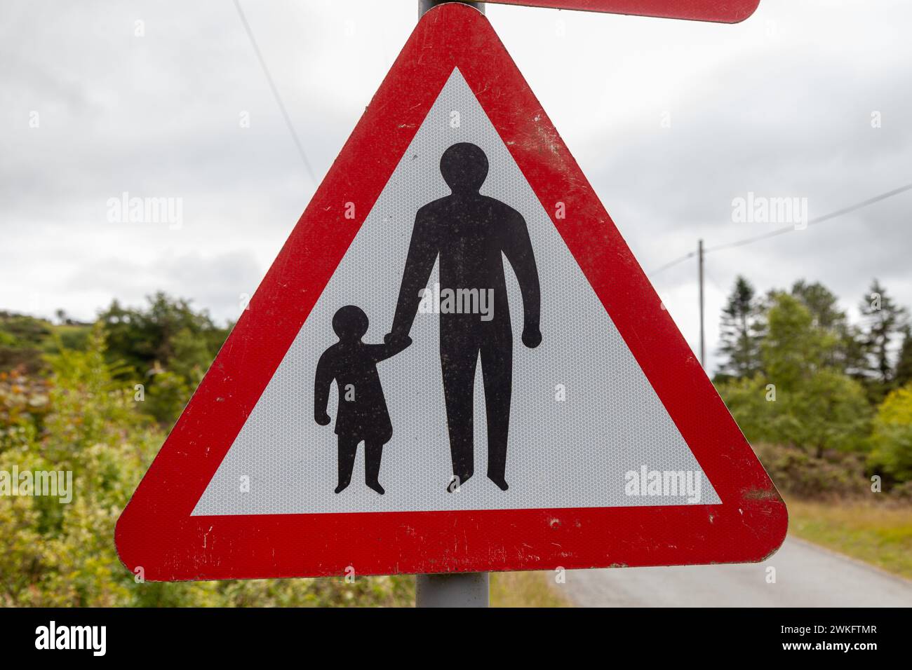 red triangle road sign warning of pedestrians walking Stock Photo - Alamy
