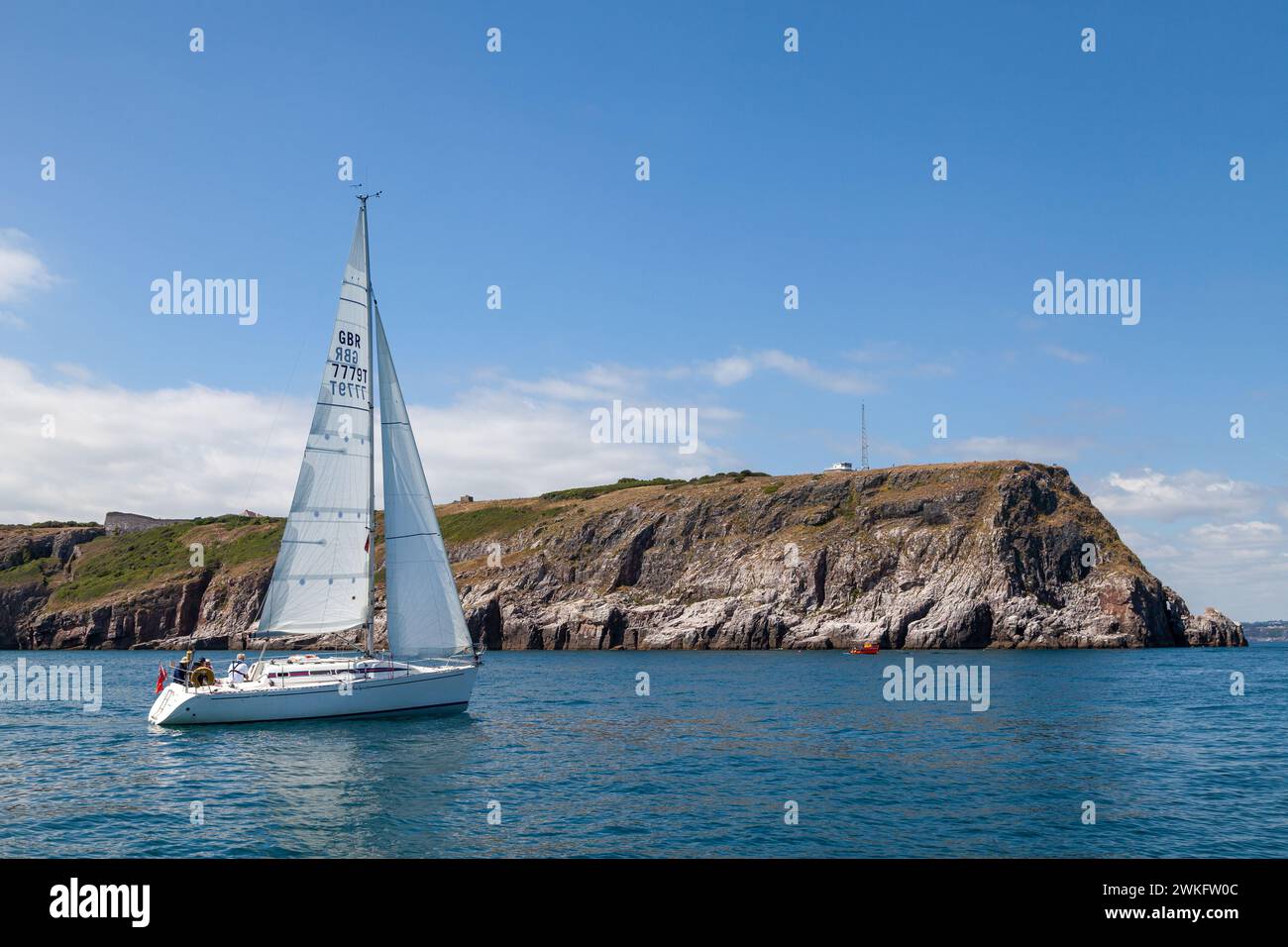 A yacht sailing past Berry Head National Nature Reserve Stock Photo - Alamy