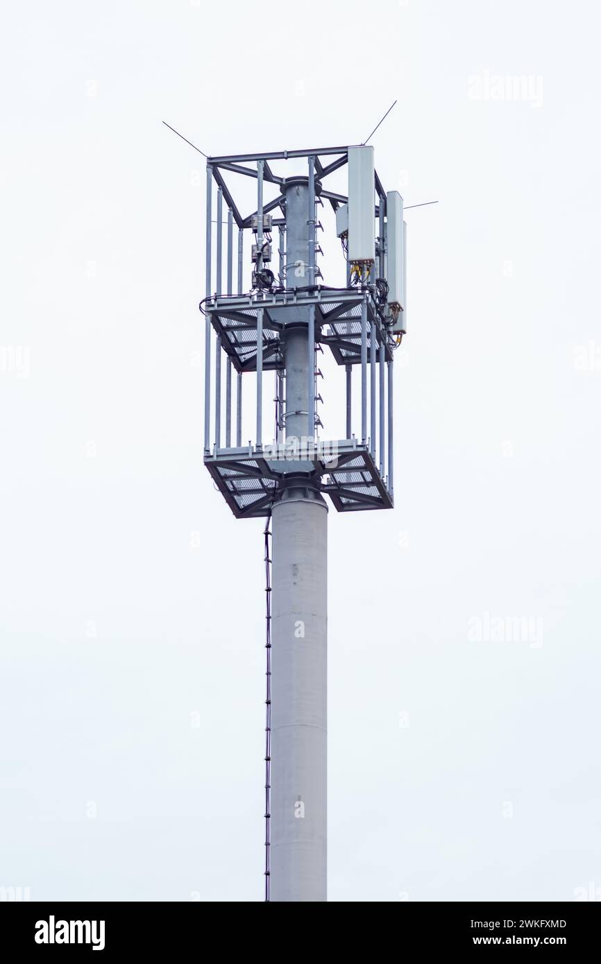 modern mobile radio tower with grey sky Stock Photo - Alamy